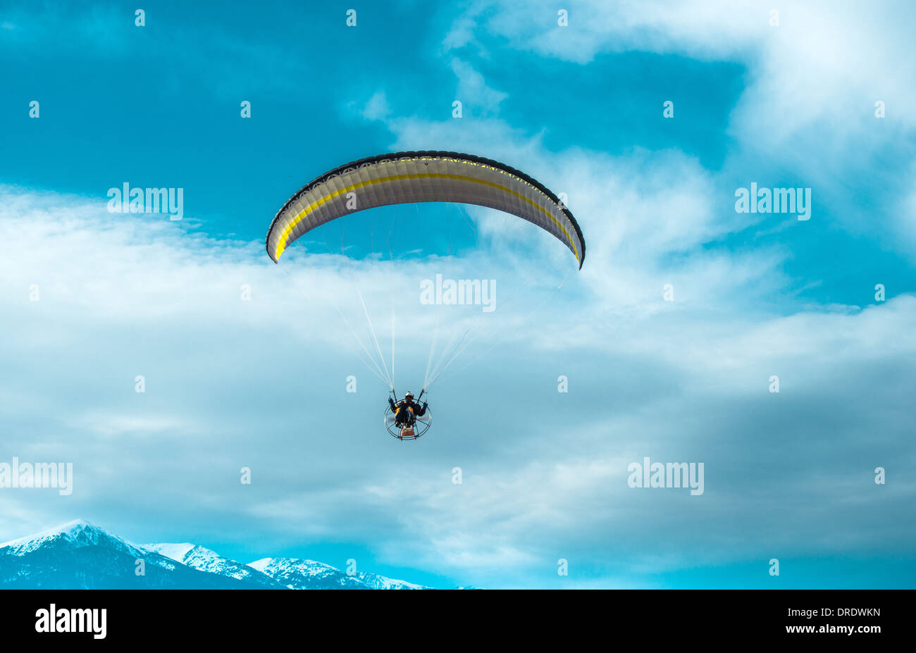 Paragliding fly on blue cloudy sky Stock Photo - Alamy
