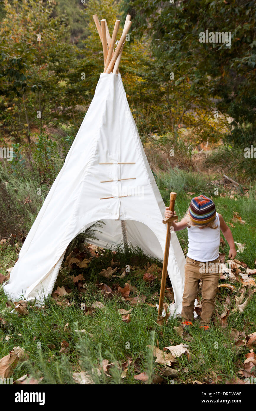 Young girl playing by toy tee pee Stock Photo - Alamy