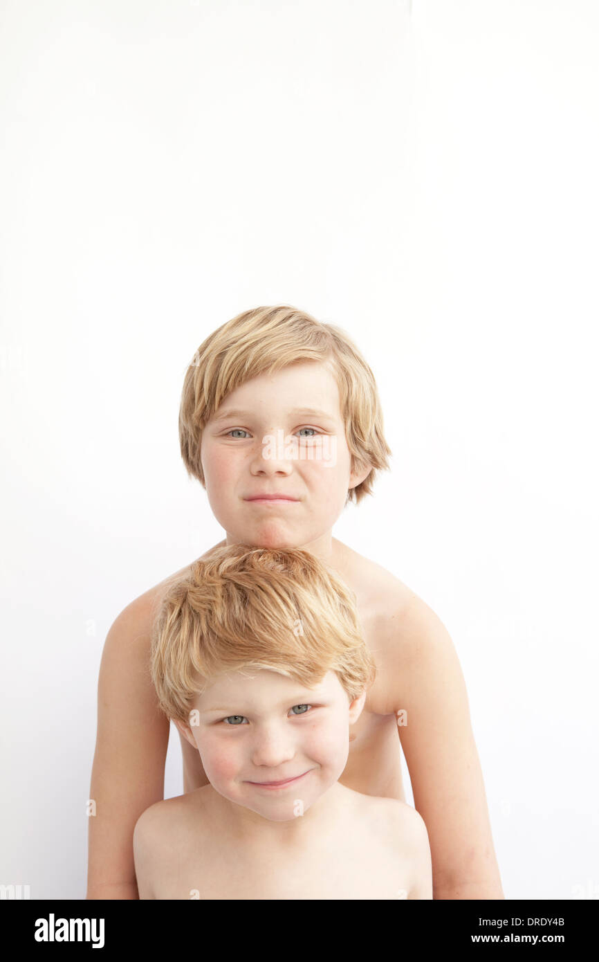 Portrait of shirtless brothers Stock Photo - Alamy