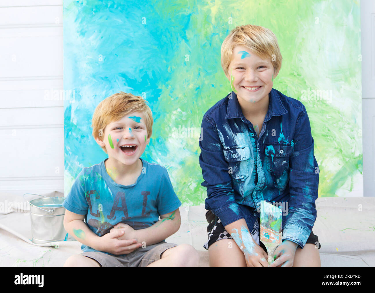 Brothers laughing in front of painting Stock Photo - Alamy