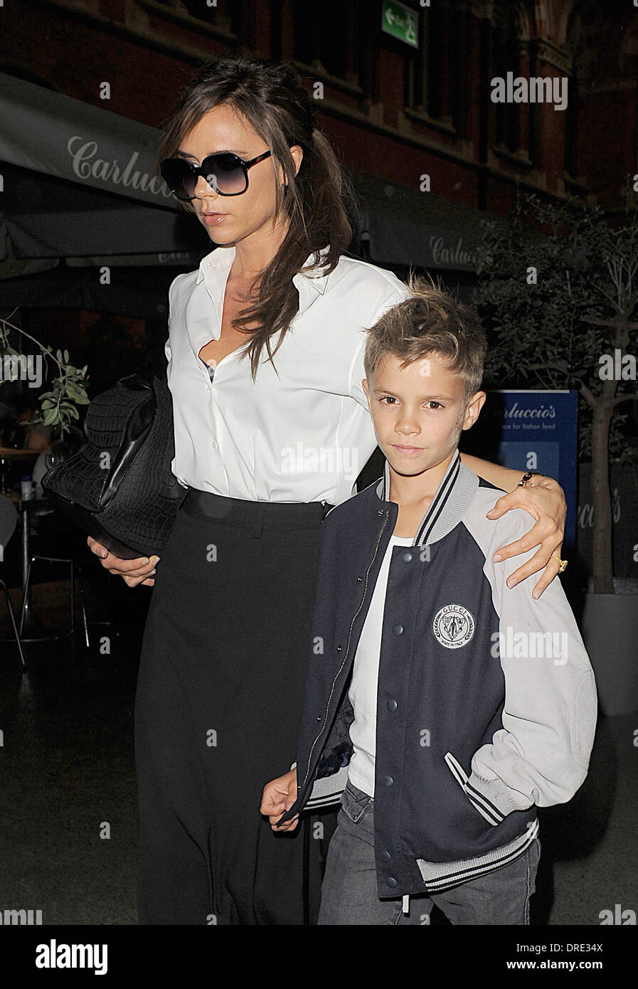 Victoria Beckham and Romeo Beckham arrive at Kings Cross St. Pancras ...
