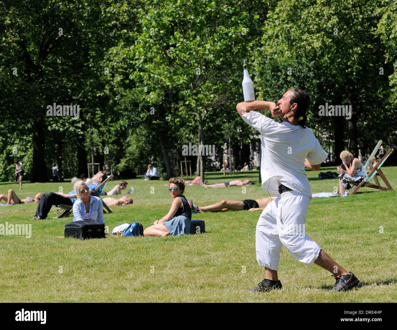 People enjoy the hot weather in Green Park. London, England - 24.07.12 ...