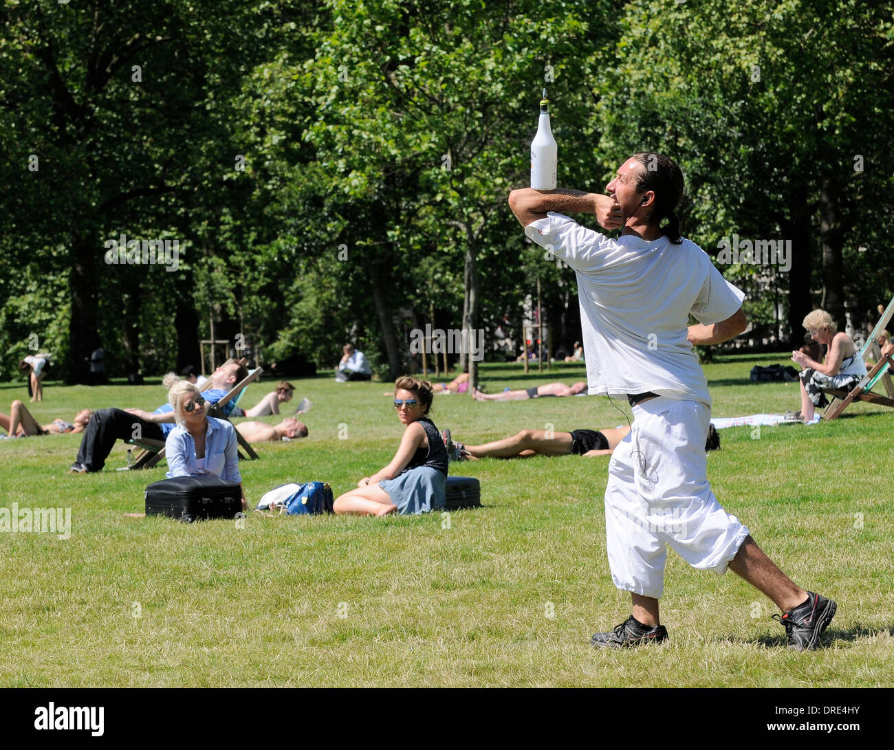 People enjoy the hot weather in Green Park. London, England - 24.07.12 ...