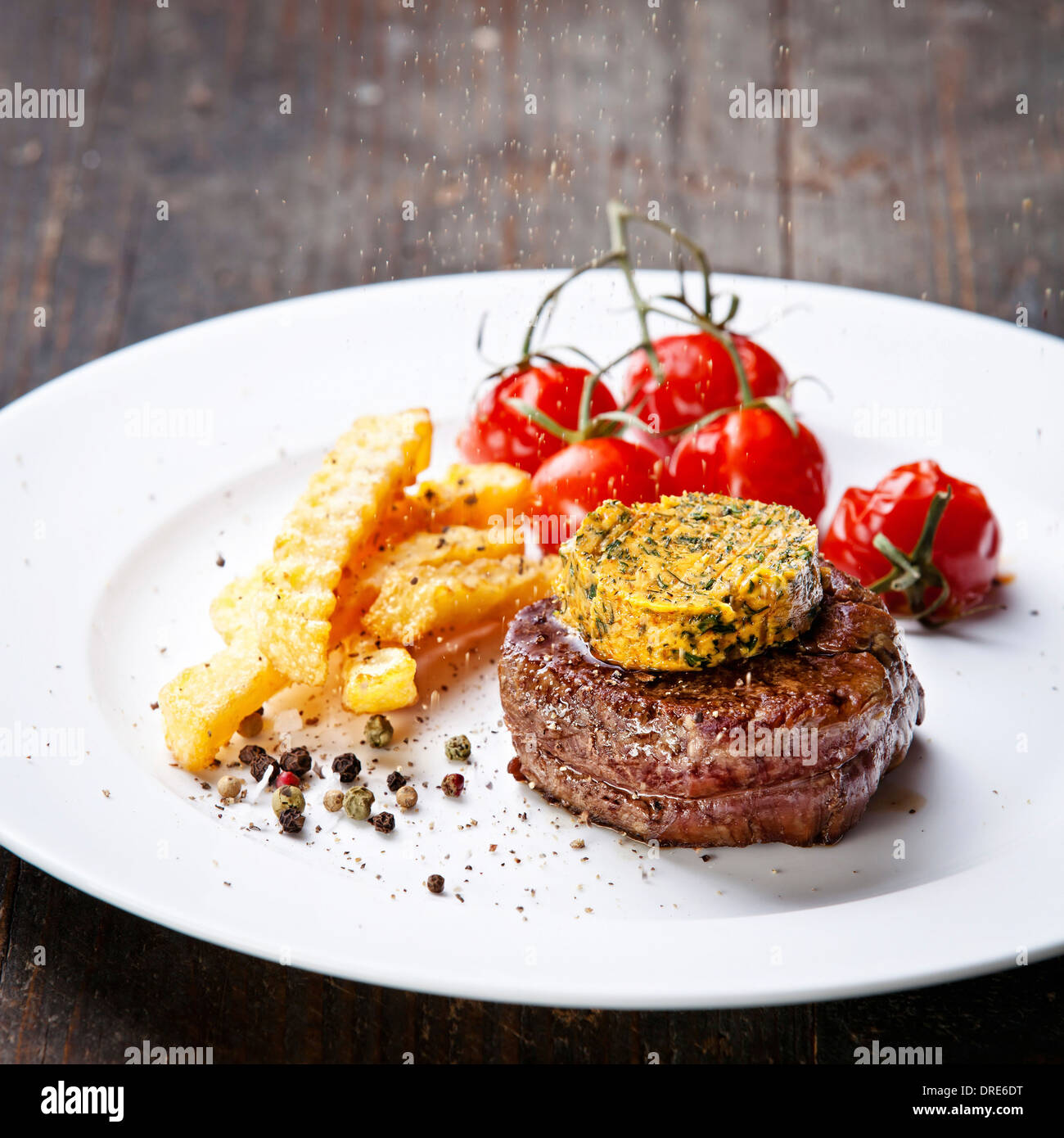 Beef Steak with Butter and Baked tomato Stock Photo - Alamy