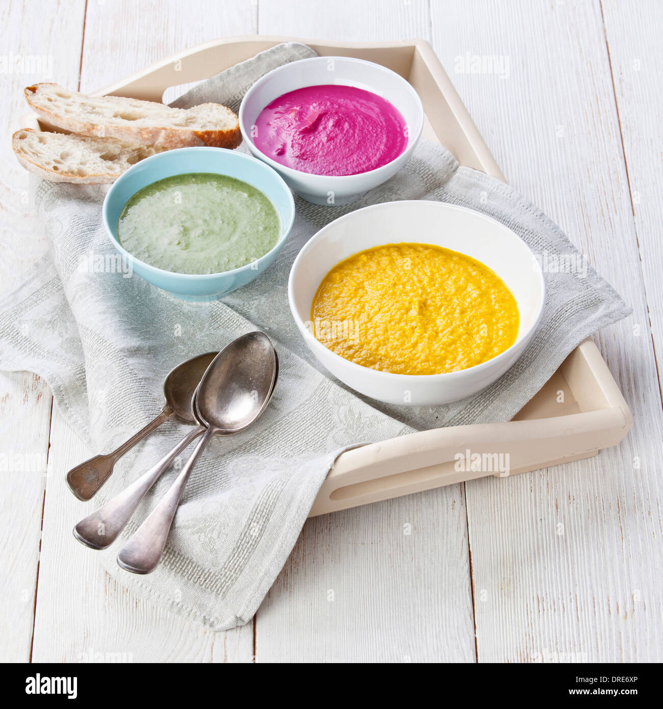 Three different coloured soups on a tray Stock Photo - Alamy