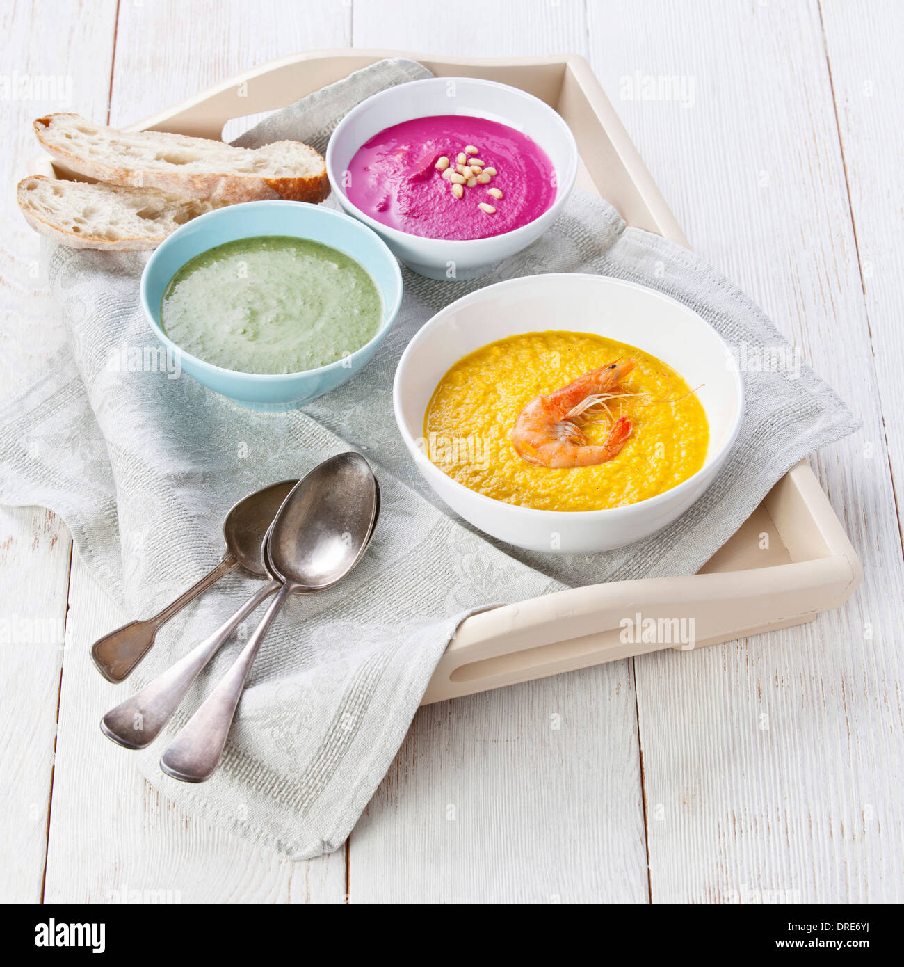 Three different coloured soups on a tray Stock Photo - Alamy