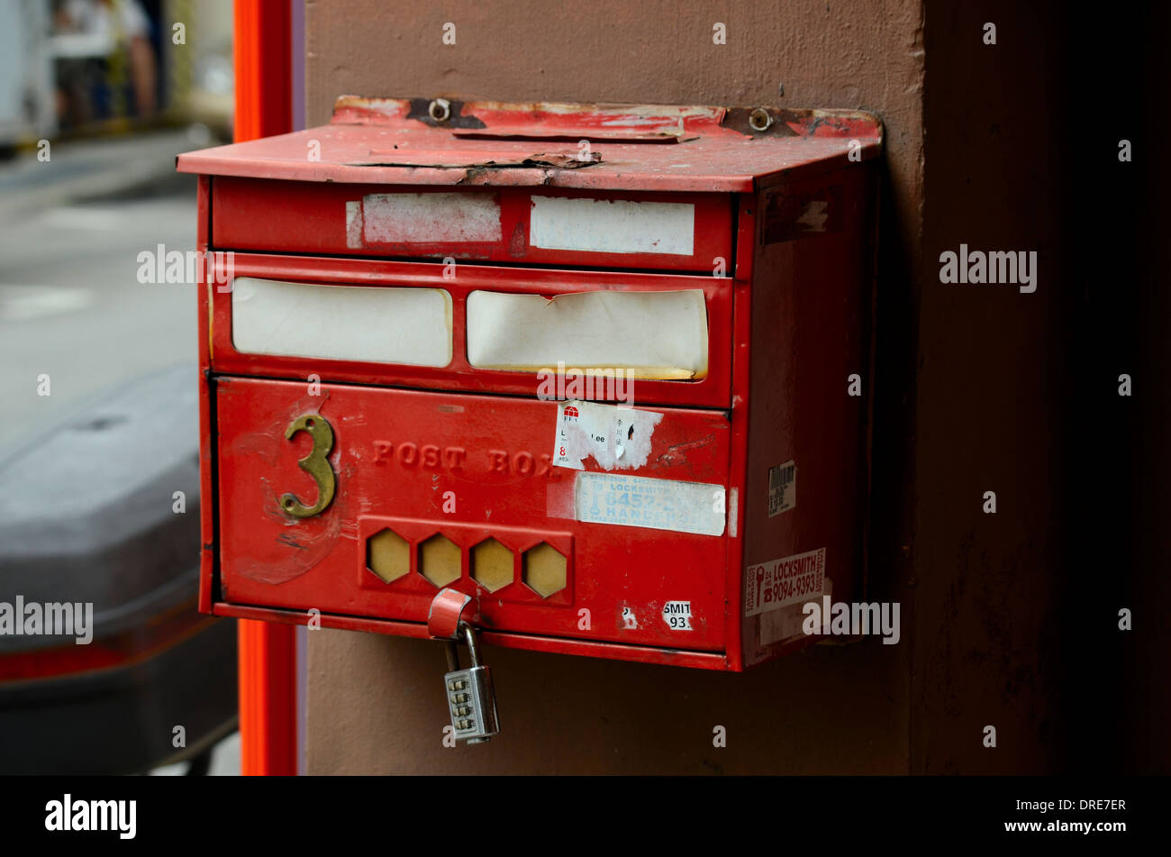 Weathered red post box on pillar with combination lock Stock Photo - Alamy