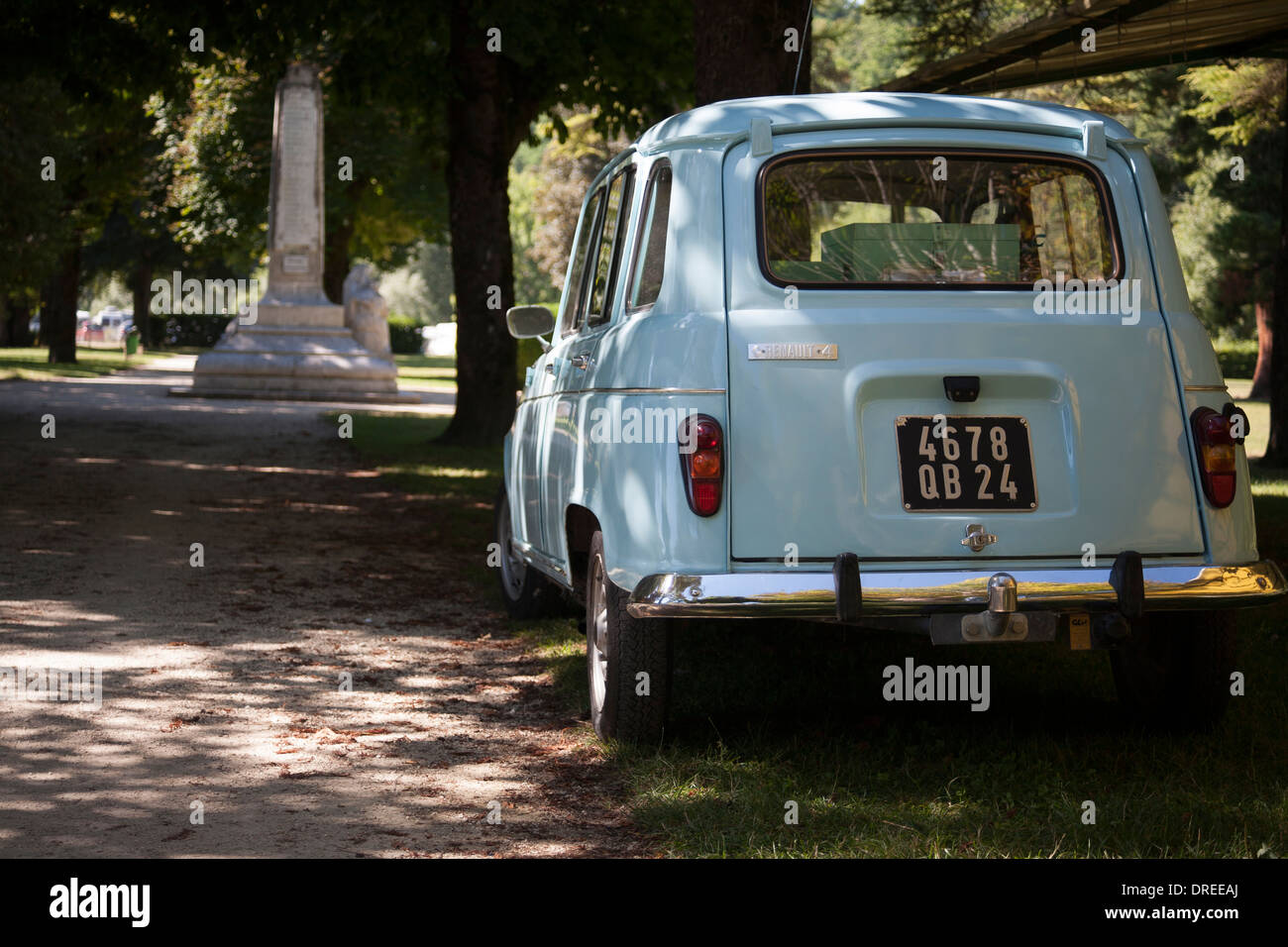 Rear view of pale blue vintage French Renault 4 car in a park in summer ...