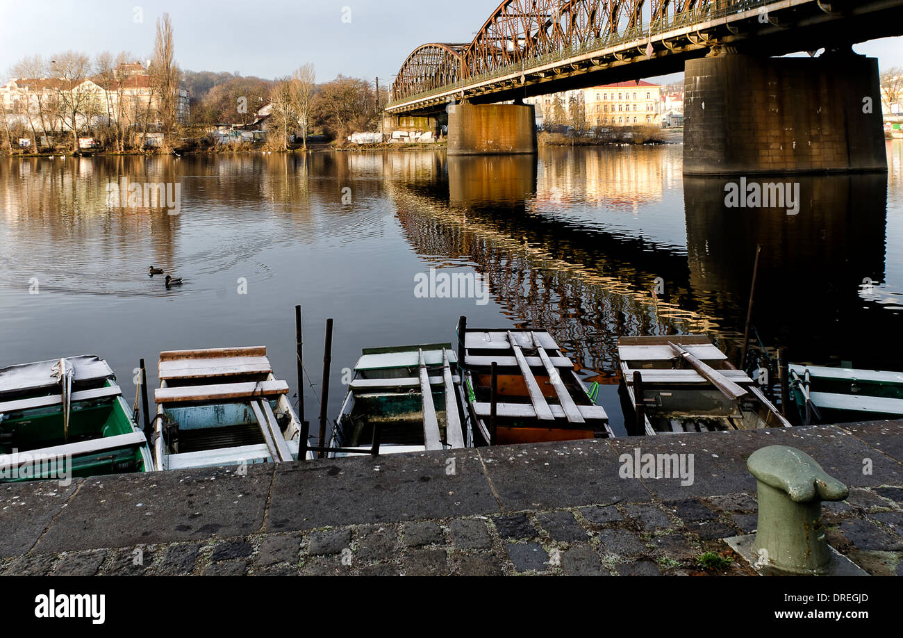 rowing boats standing by the shore under the bridge in Prague Stock ...
