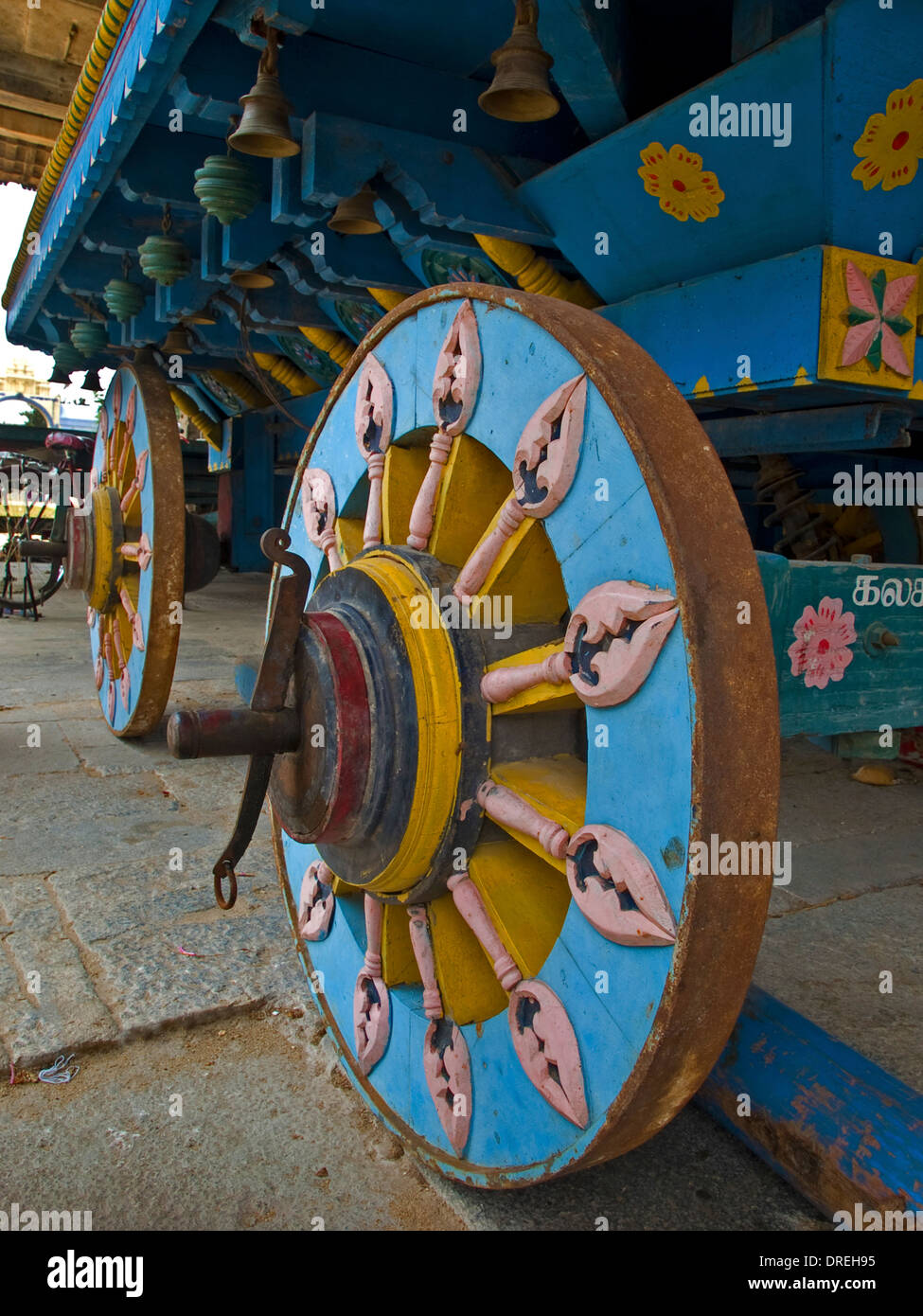 the wheel of a temple carriage standing in the corner of a temple ...