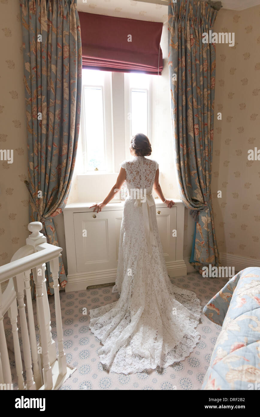 bride looking out the window awaiting the ceremony Stock Photo - Alamy