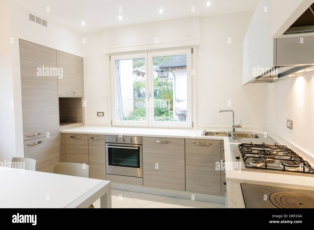 Modern kitchen interior with wooden cabinets and white table Stock ...