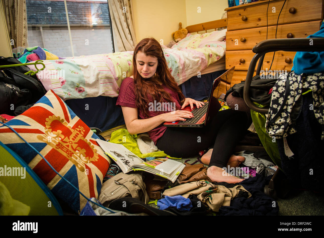 A young woman university student studying working on her laptop ...