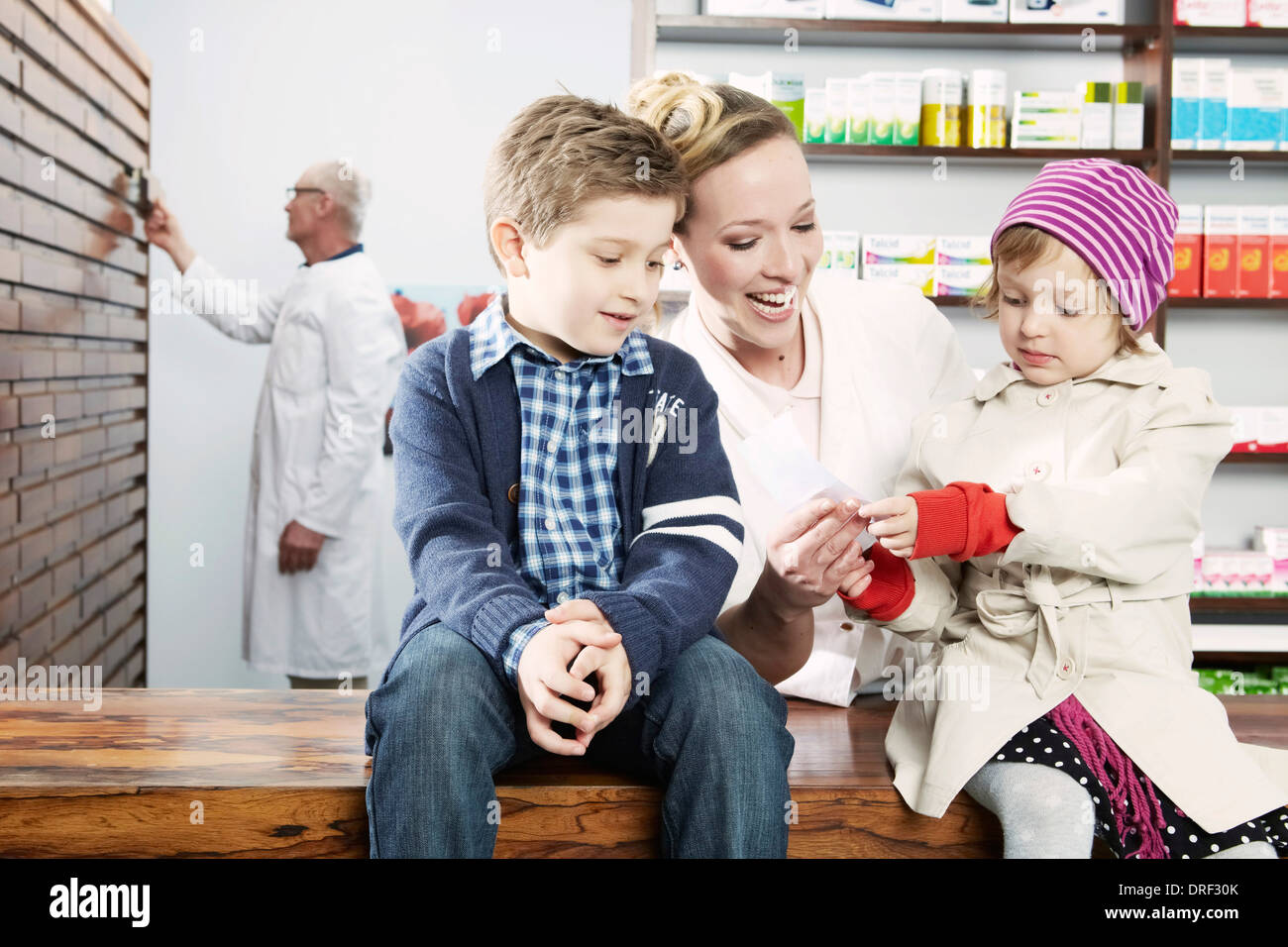 Female Pharmacist Talking With Children, Munich, Bavaria, Germany Stock ...