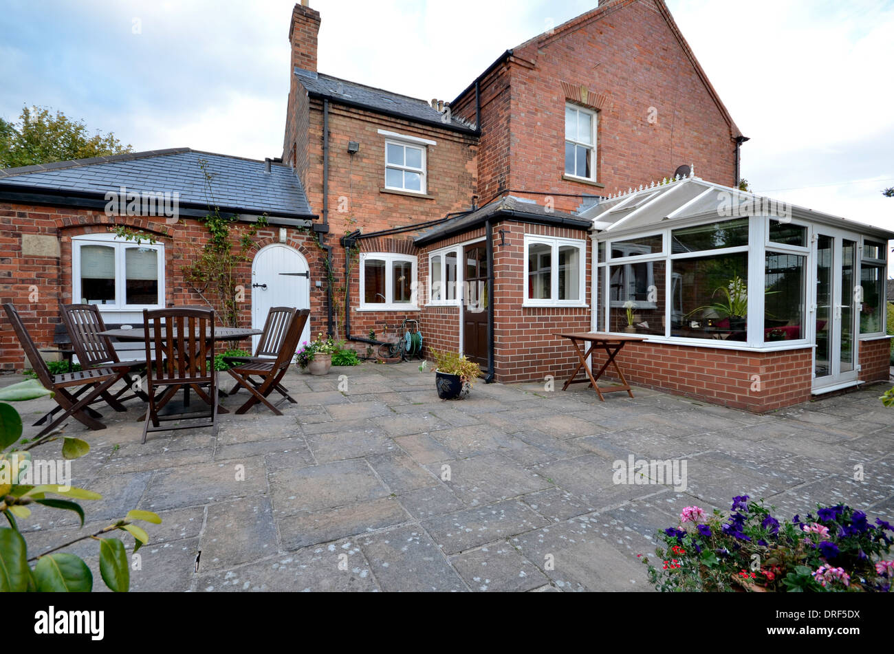 Conservatory with patio and alfresco dining are Stock Photo - Alamy