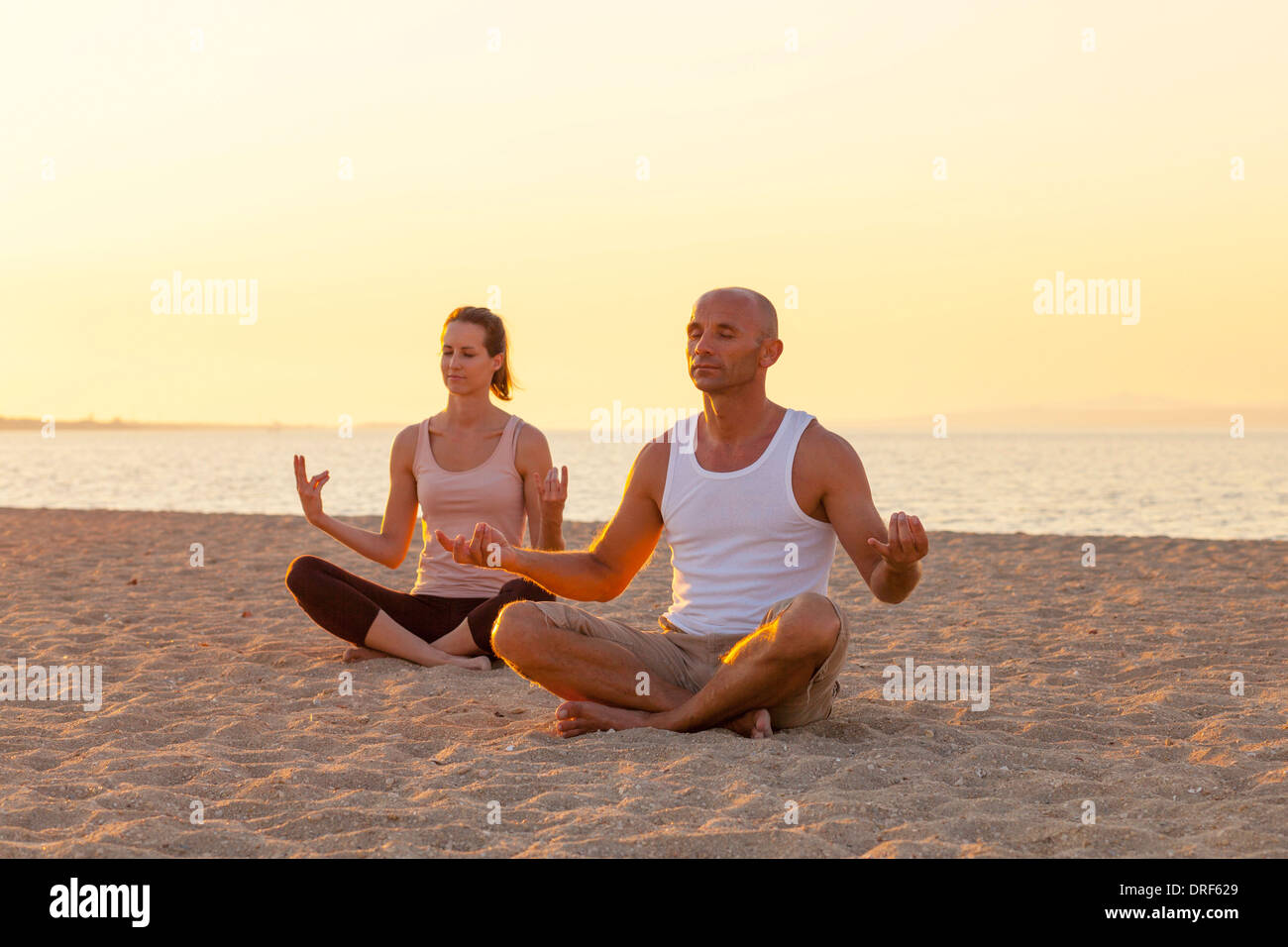 Woman practising lotus pose outdoors hi-res stock photography and ...