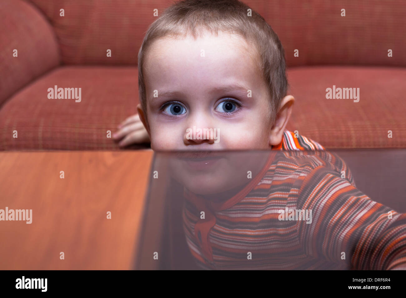 Hiding behind table hi-res stock photography and images - Alamy