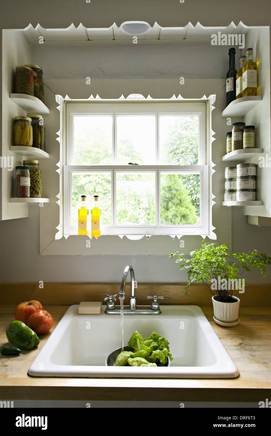 Maryland USA Kitchen window with shelves traditional sink tap Stock ...
