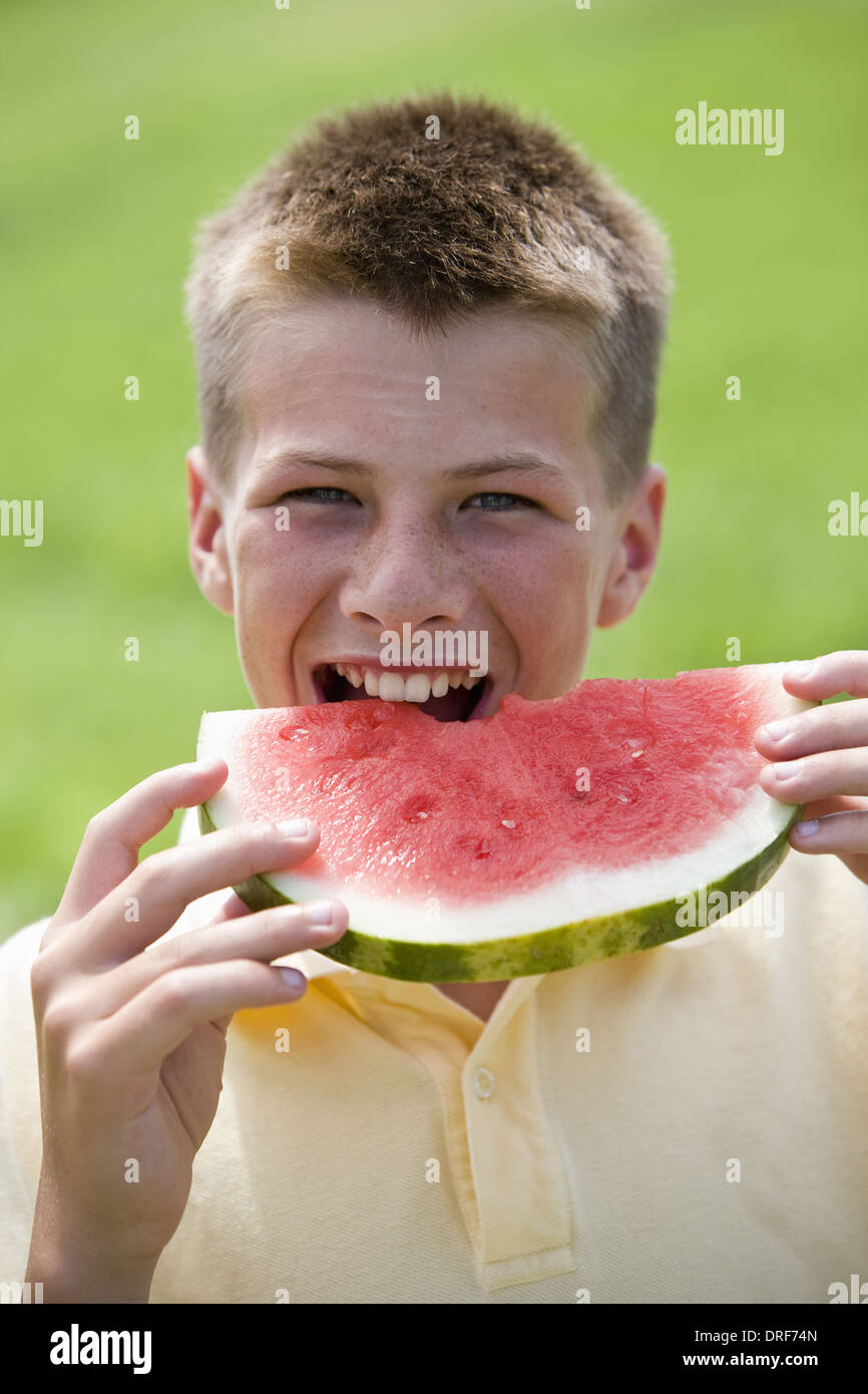 Maryland USA teenage boy taking large bite out of watermelon Stock ...