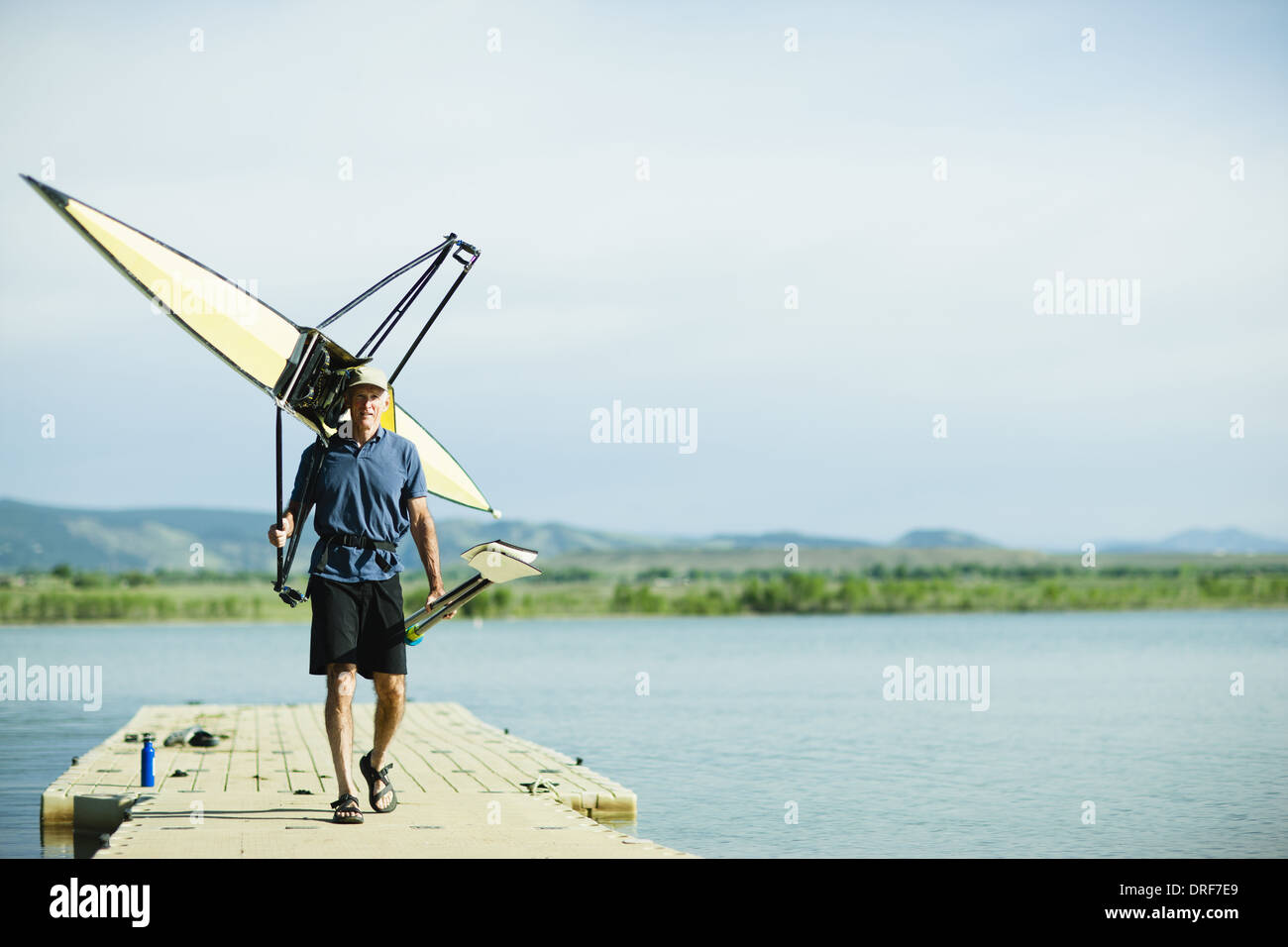 Colorado USA middle-aged man carrying oars and rowing shell Stock Photo ...