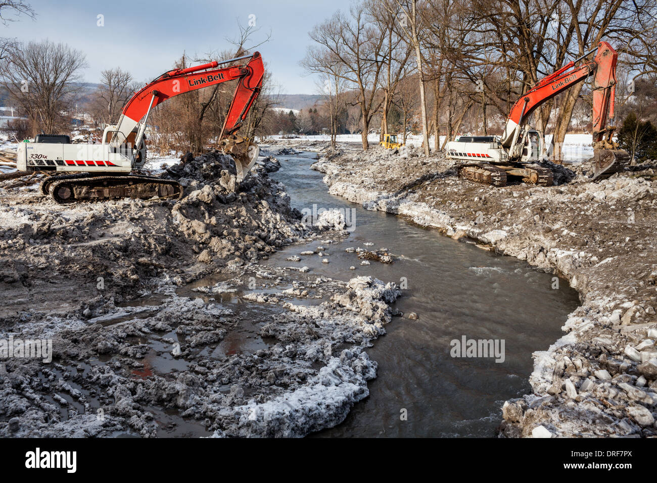 Dredging ice from a creek to prevent ice jams from causing floods ...