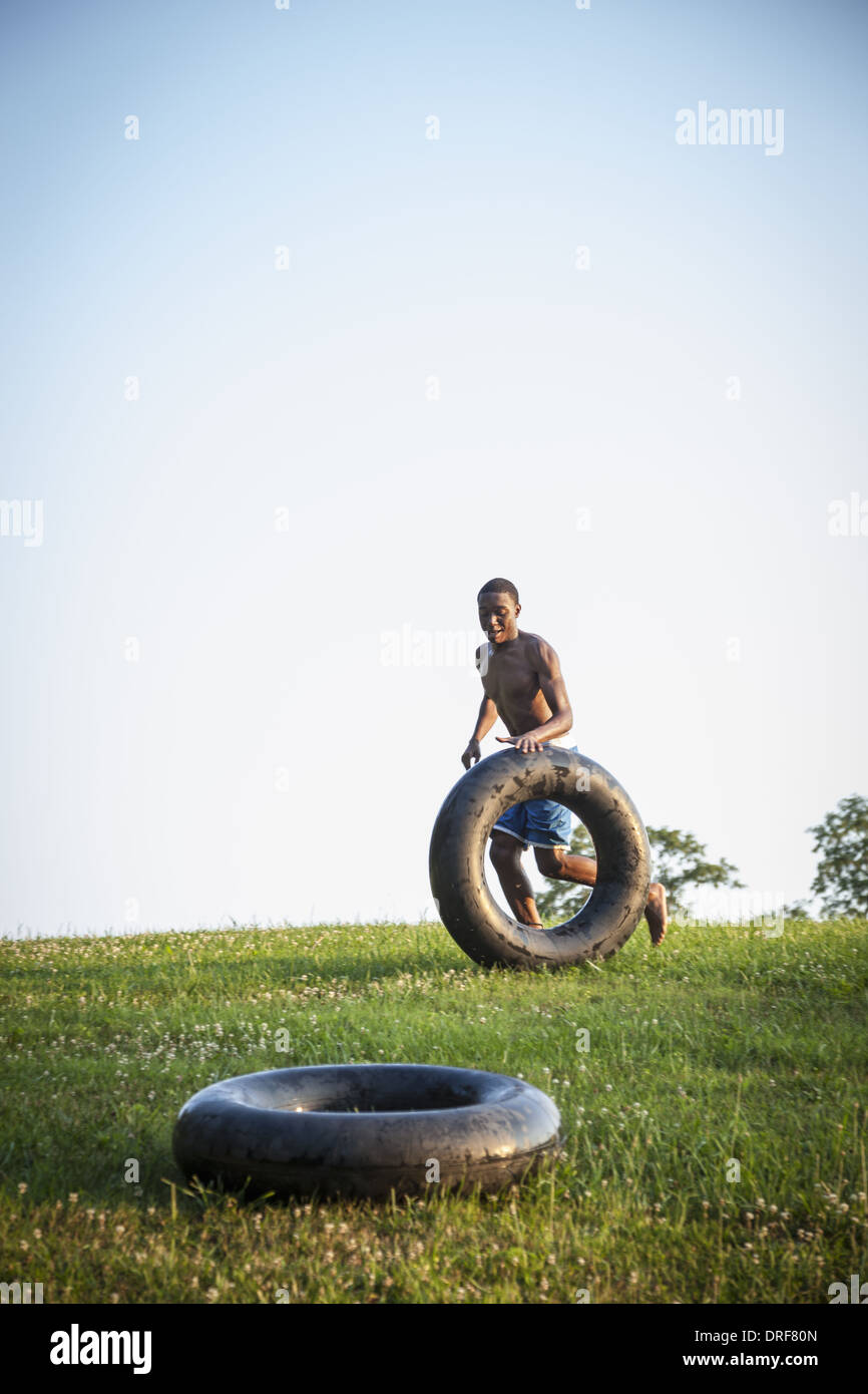 Boy rolling tire hi-res stock photography and images - Alamy