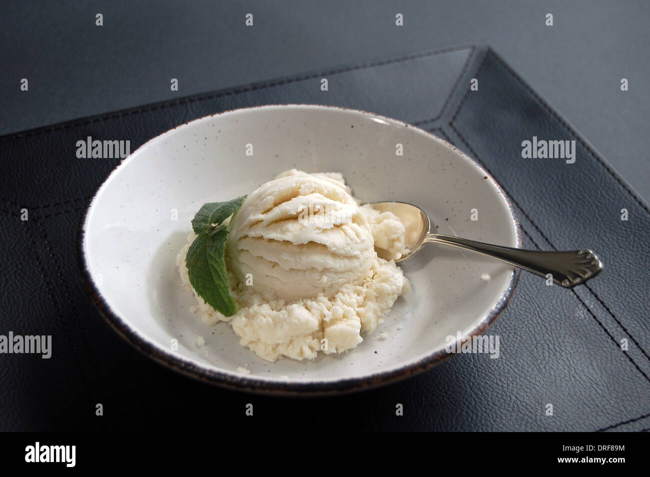Bowl of vanilla ice cream with a mint sprig Stock Photo - Alamy