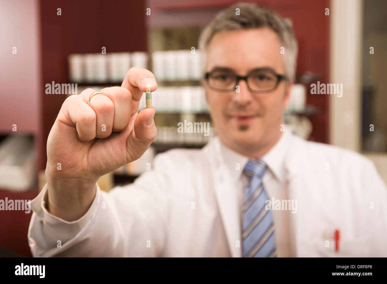 Male Pharmacist Holding Pill, Munich, Bavaria, Germany Stock Photo - Alamy