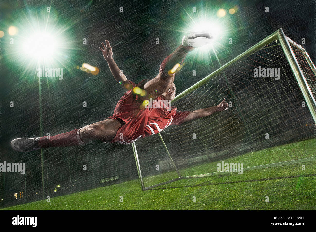 Soccer playing performing a bicycle kick in front of goal Stock Photo ...