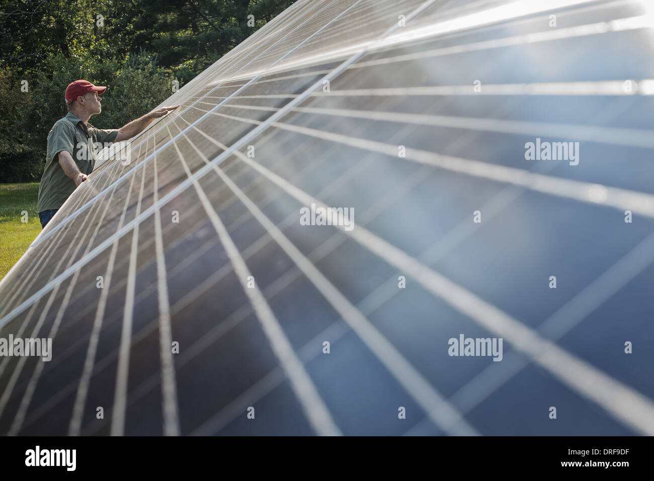 New York state USA man inspecting surface solar panel installation ...