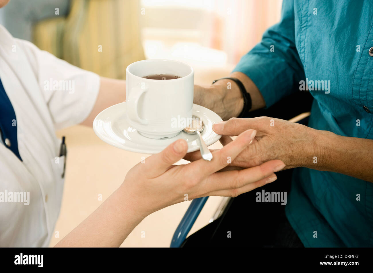 Senior woman receiving a cup of tea in nursing home, Bavaria, Germany ...