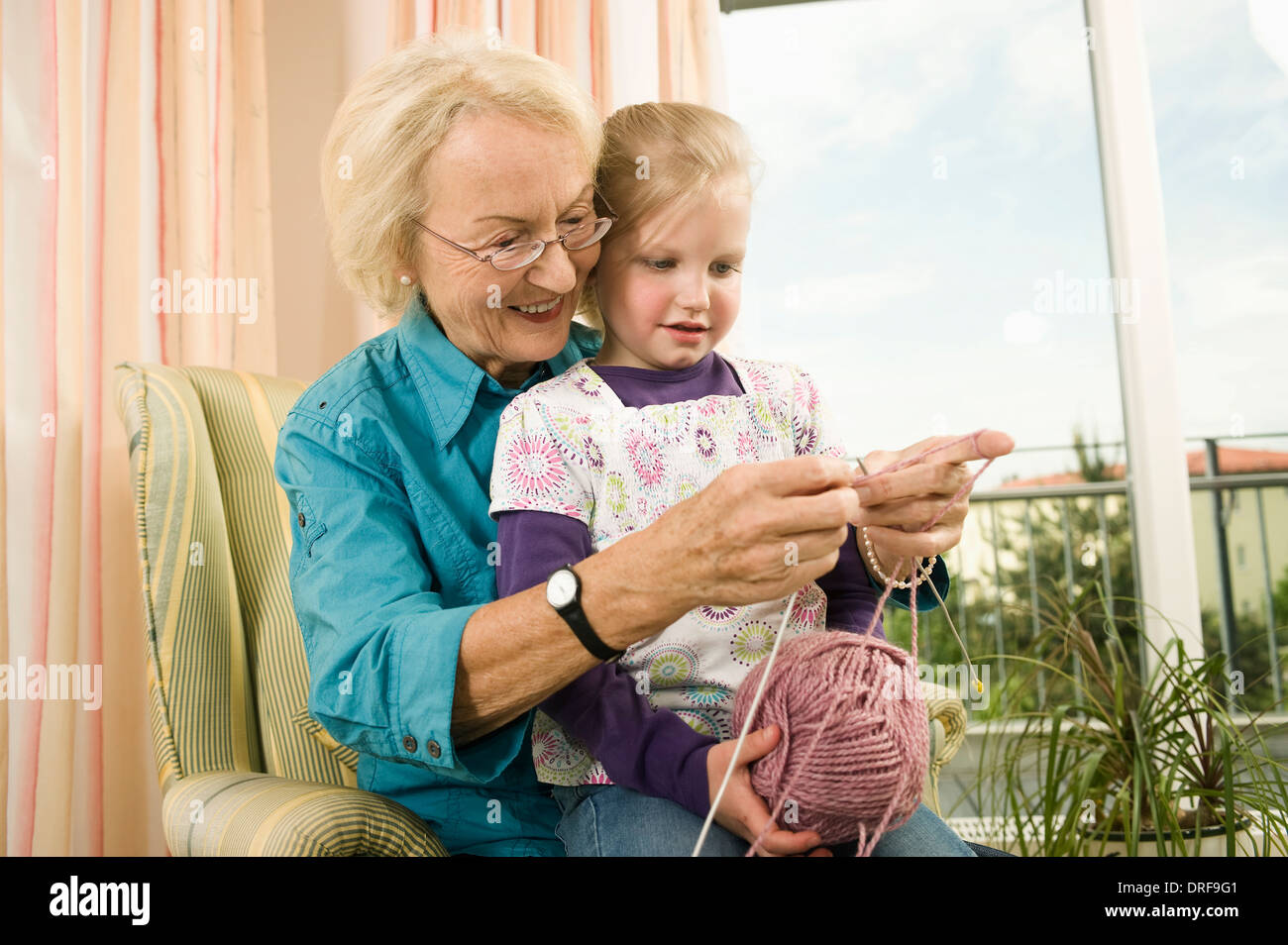 Grandparent teaching grandchild knit hi-res stock photography and ...