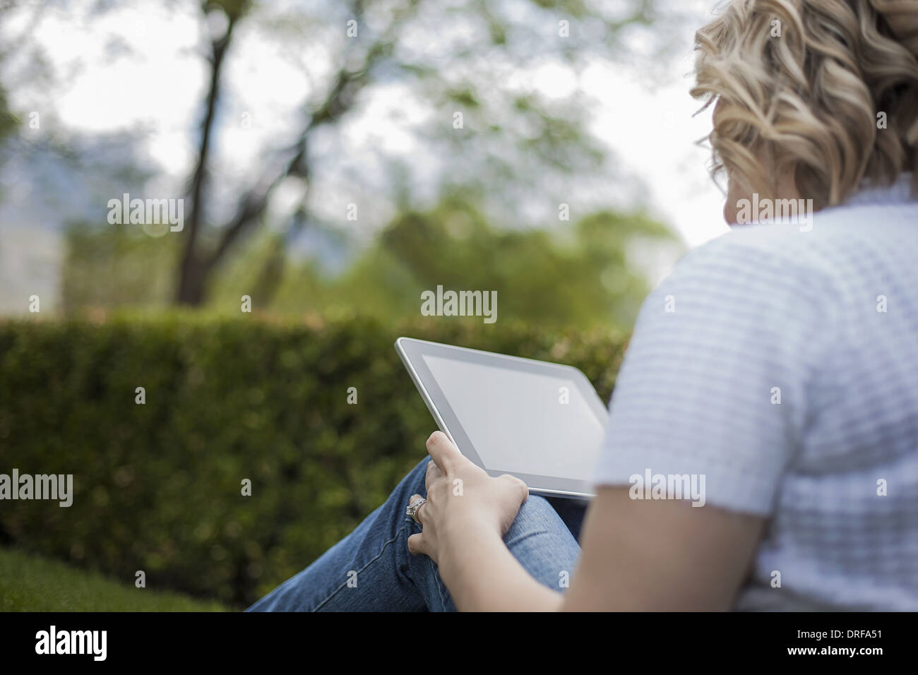Utah USA young woman reading using handheld tablet Stock Photo - Alamy