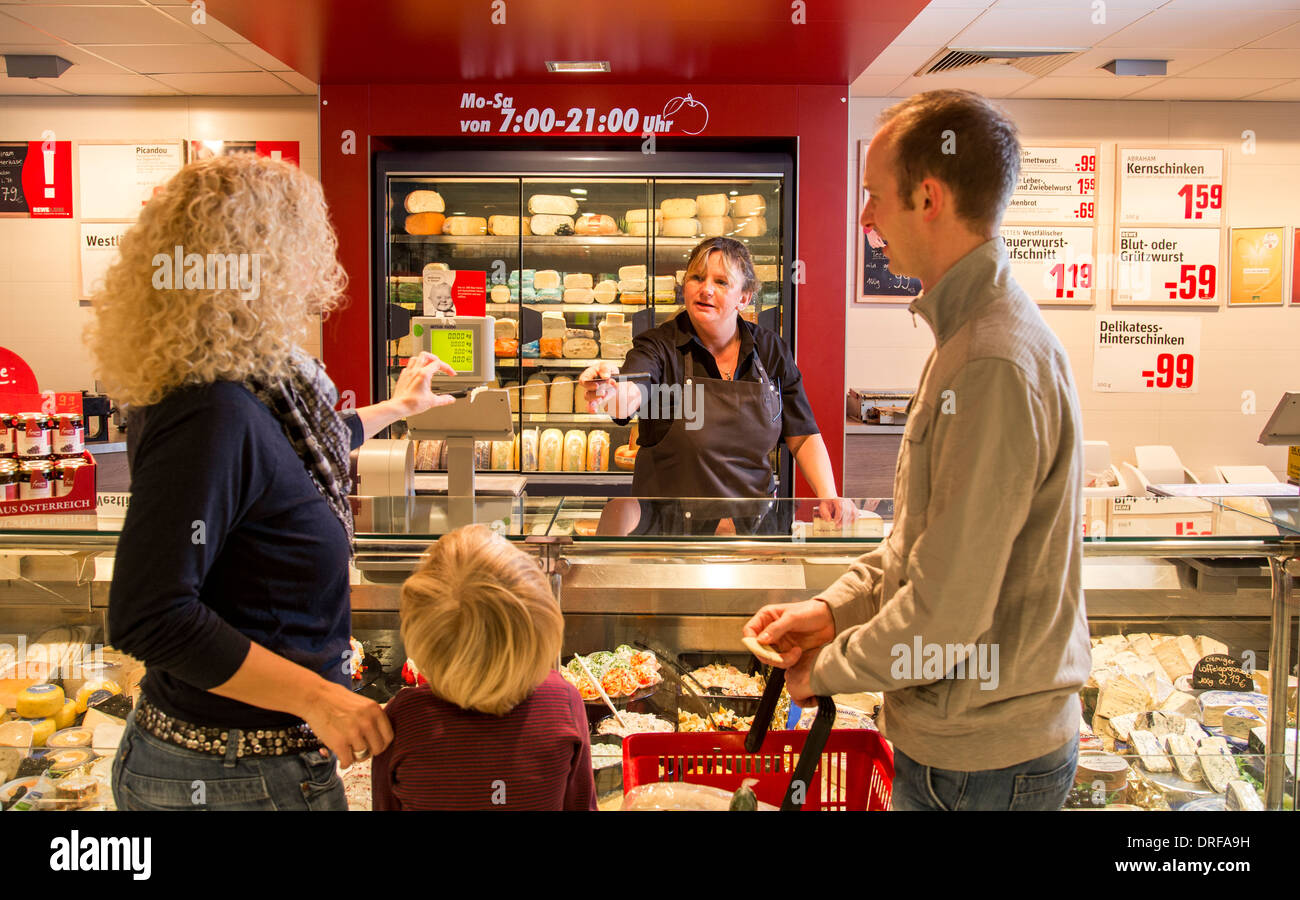 Young family shopping in a supermarket, cheese counter Stock Photo - Alamy
