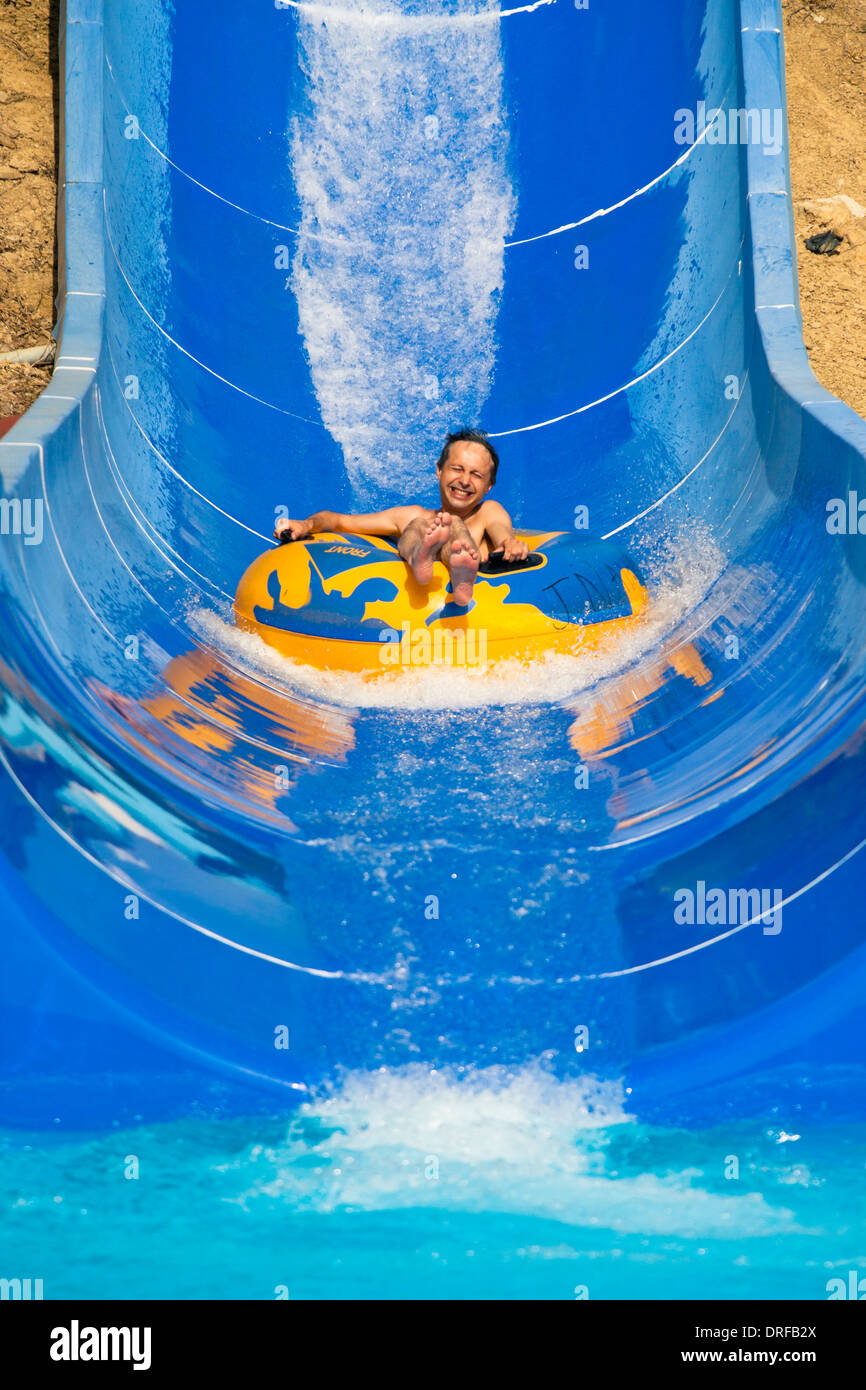 Man water sliding at aqua park Stock Photo - Alamy