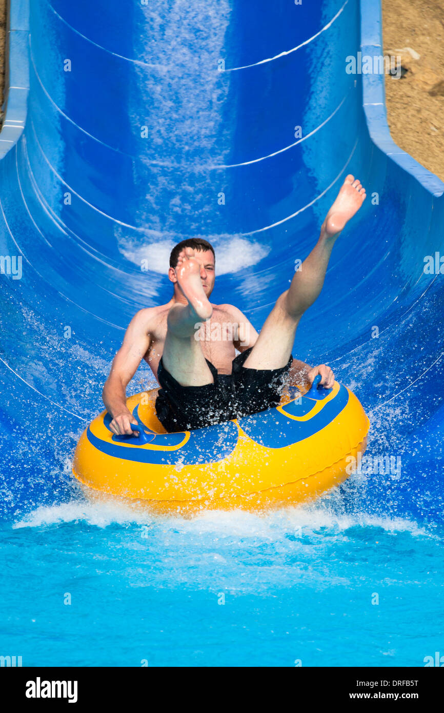 Man water sliding at aqua park Stock Photo - Alamy