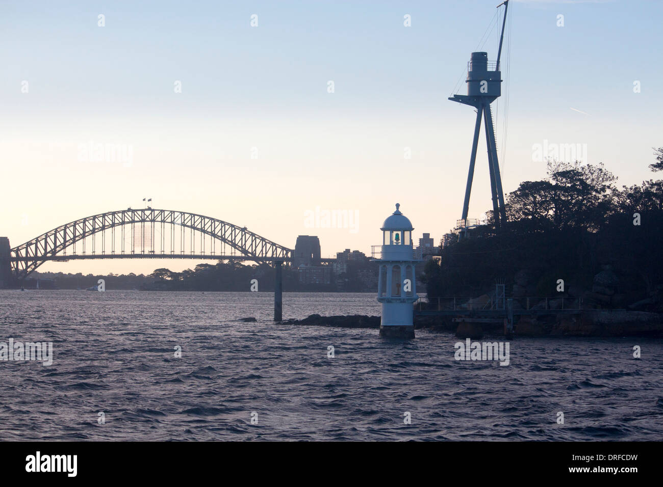 Sydney Harbour Bridge from ferry passing Bradleys Head lighthouse and ...