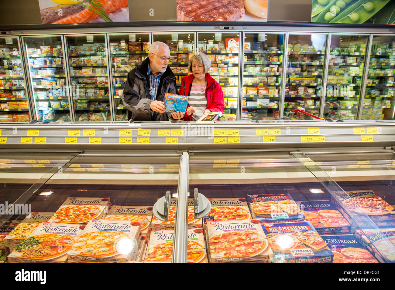 Older couple buys in a supermarket. Frozen food department Stock Photo ...