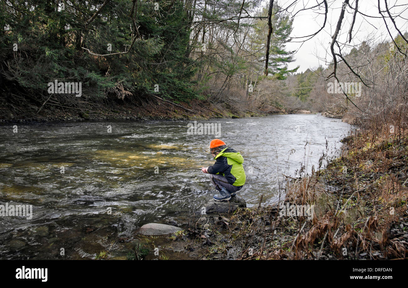 Boy fishing on riverbank hi-res stock photography and images - Alamy