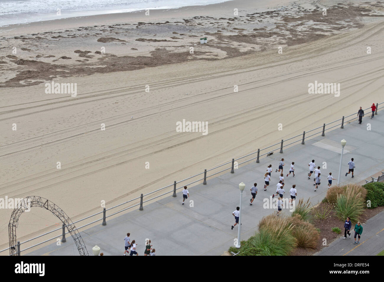 Young people run in a race by the sea on the Virginia Beach Boardwalk ...