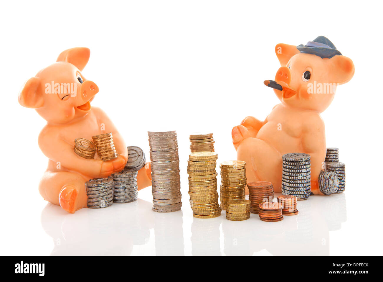 Two piggy bank and piles of coins over white background Stock Photo - Alamy
