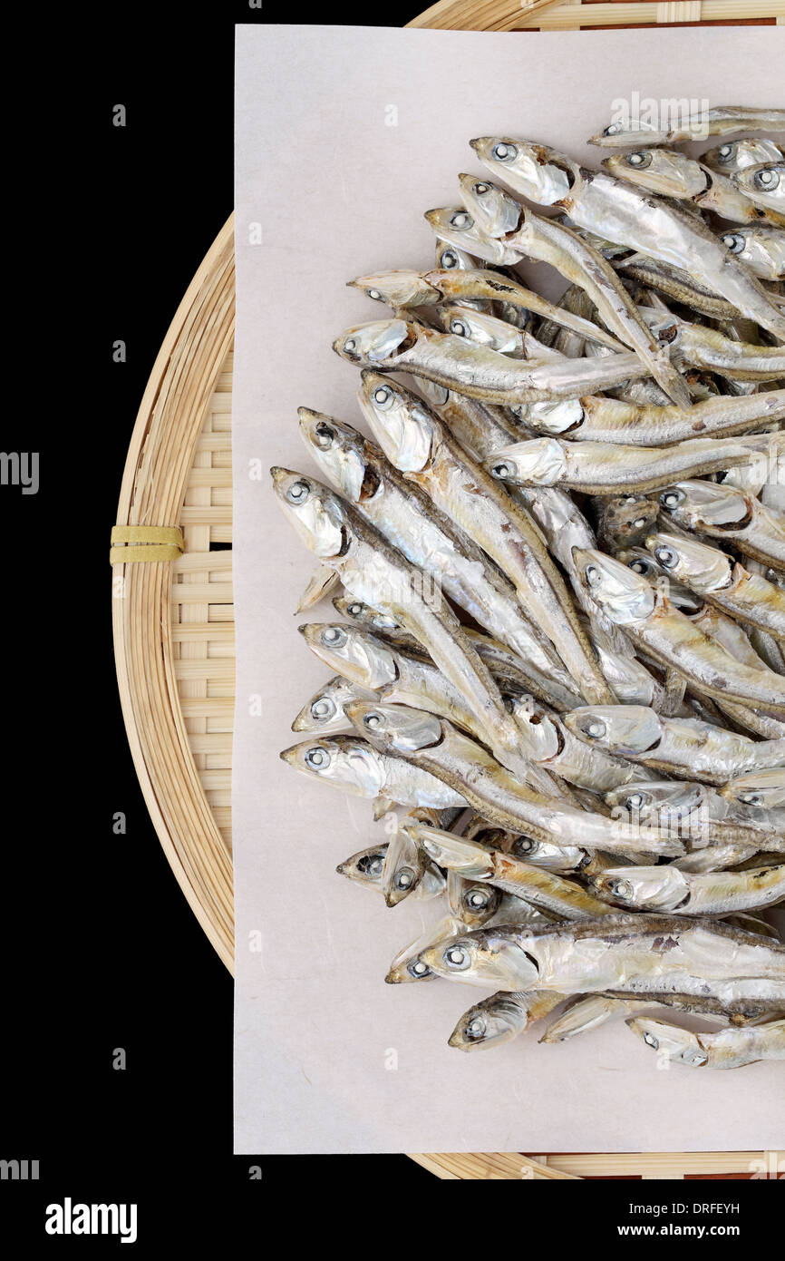 Dried small fish on bamboo colander Stock Photo - Alamy