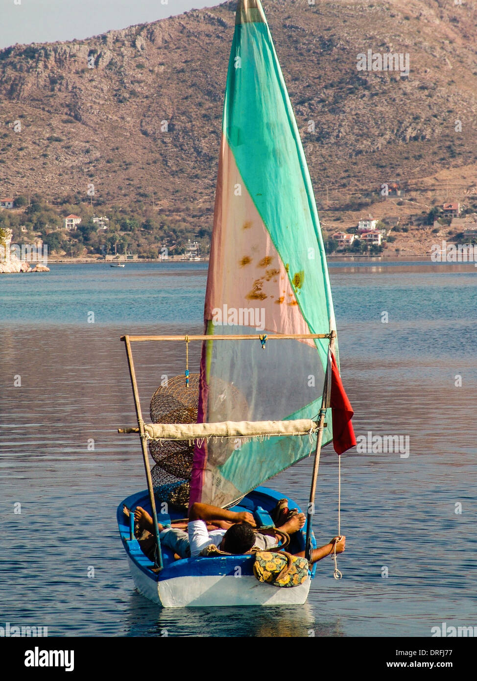 sailor is sailing his fishing boat with a selfmade sail Stock Photo - Alamy