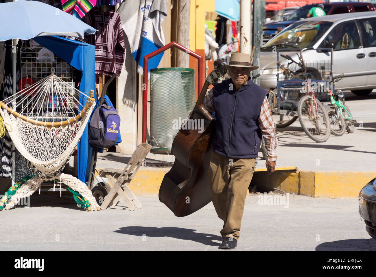 Elderly gentleman carries his bass fiddle on the streets of Nuevo ...