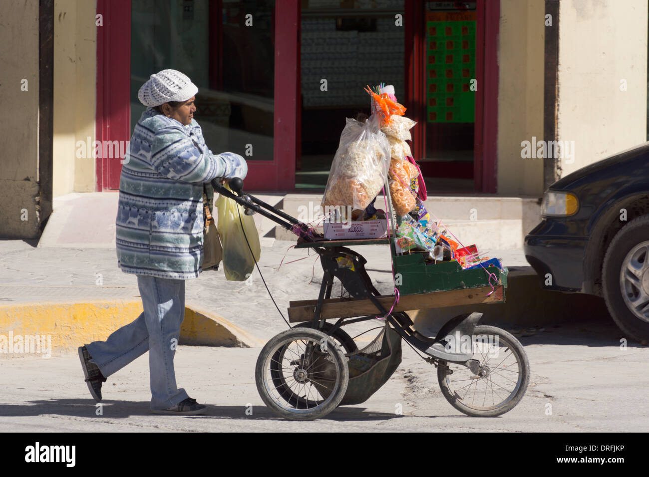 Street vendor pushes her cart on the streets of border town, Nuevo ...