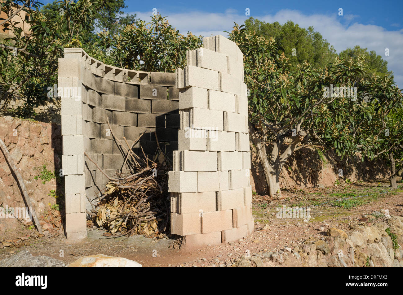 Simple concrete structure to safely burn pruning waste Stock Photo - Alamy