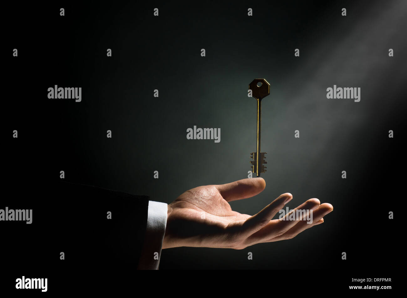 a man pointing to the gold key Stock Photo - Alamy