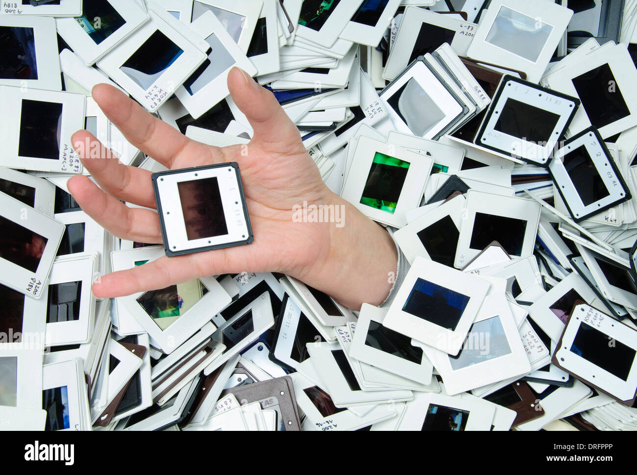 Hand holding a slide coming out of a pile of color slides Stock Photo ...