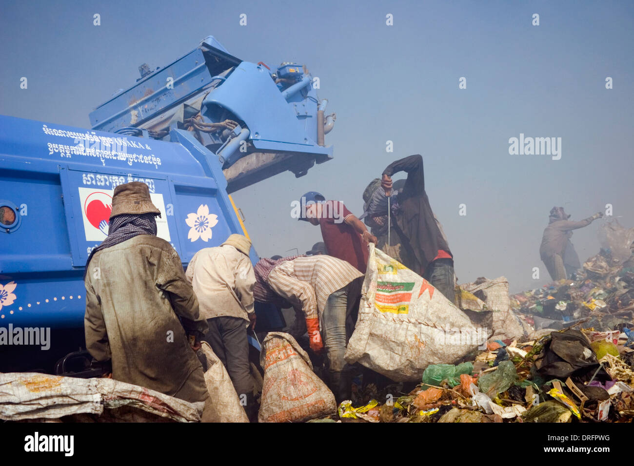 A group of scavengers are collecting recyclable material at the toxic ...