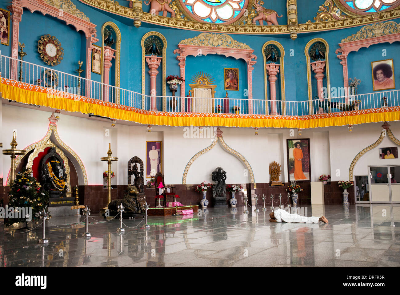 Indian man prostrating Inside the prayer hall at Sathya Sai Baba Super ...